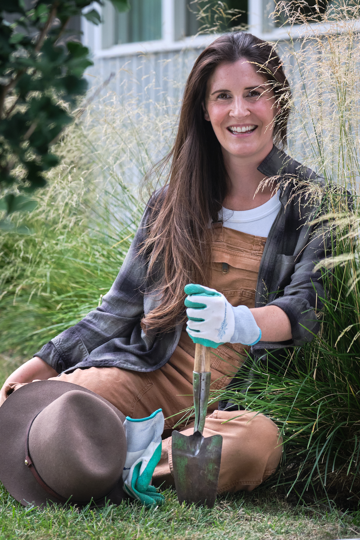 smiling gardener with hair down and trowel – Home for the Harvest